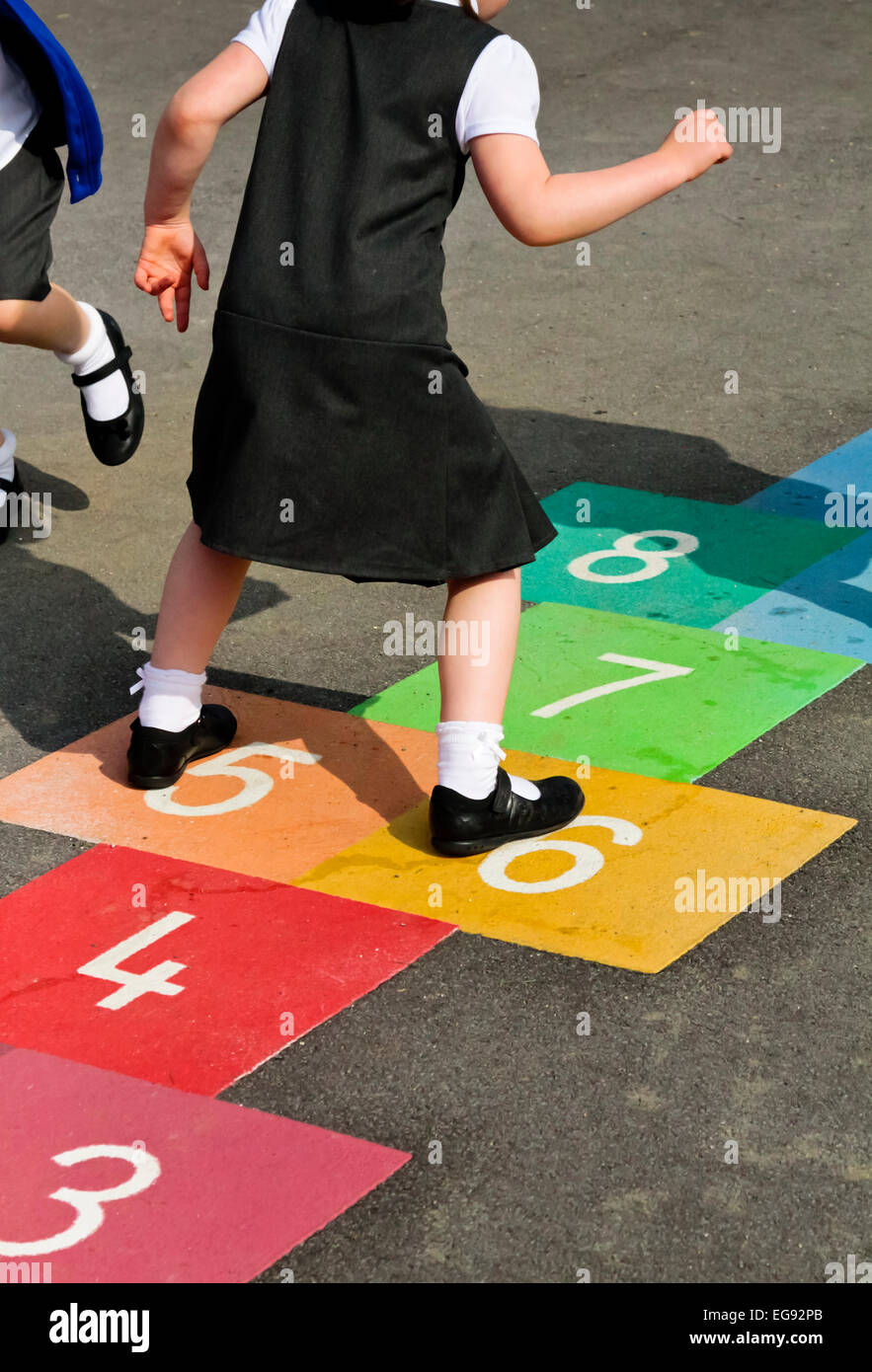 Primary schoolchildren playing in a school playground at break time ...