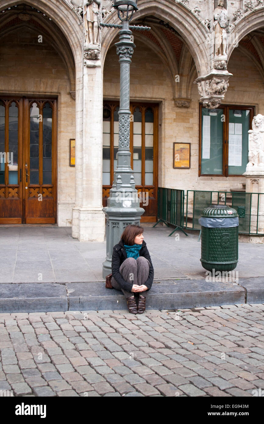 Young woman sitting on curb hi-res stock photography and images - Alamy