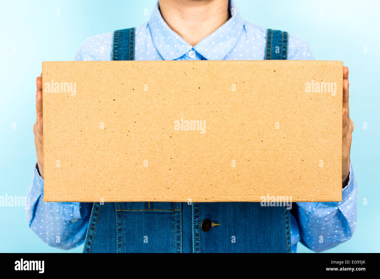 Woman holding an empty box, cardboard, front view Stock Photo - Alamy