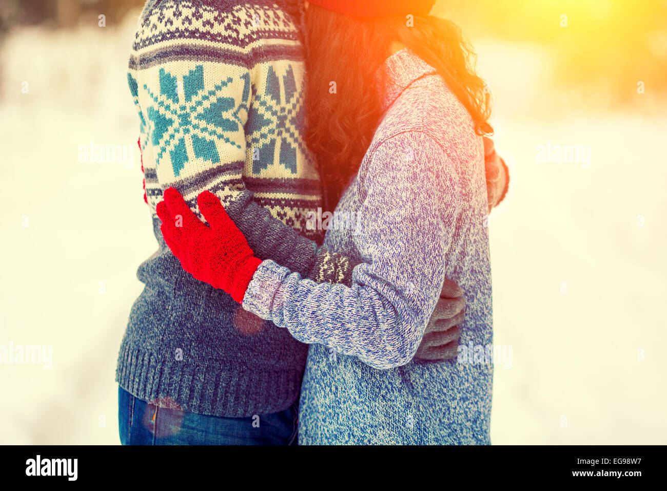 Young couple wearing a sweaters hugging outdoors in winter Stock Photo ...