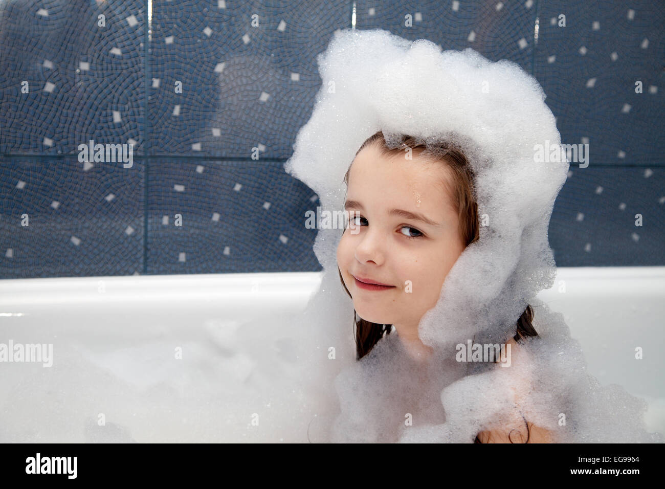 portrait of little girl sitting in a bath with soap suds Stock Photo ...