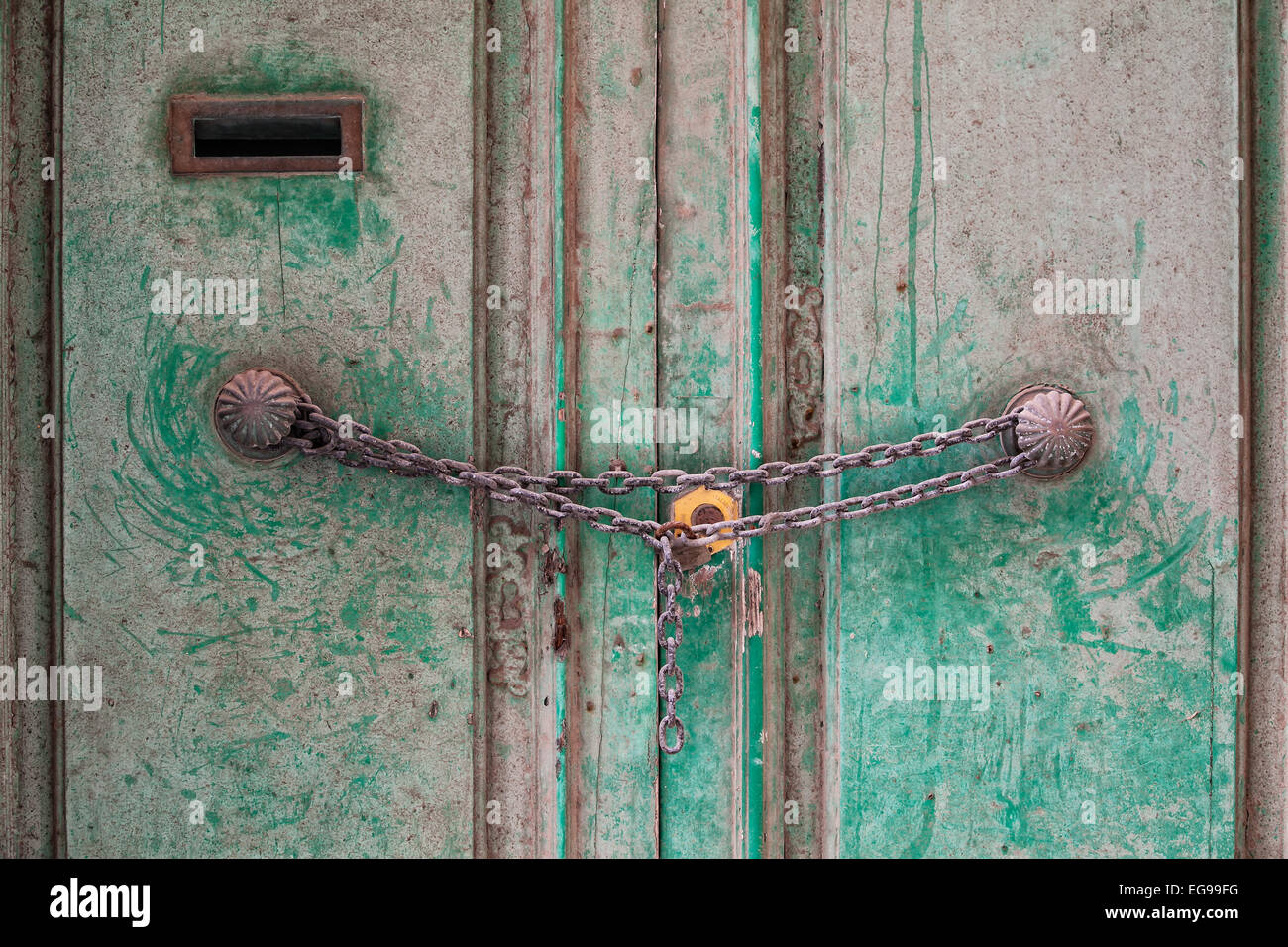 An old traditional door locked with chain and padlock Stock Photo - Alamy