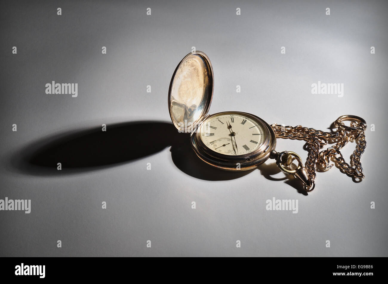 Silver pocket watch with chain on a clear surface Stock Photo - Alamy