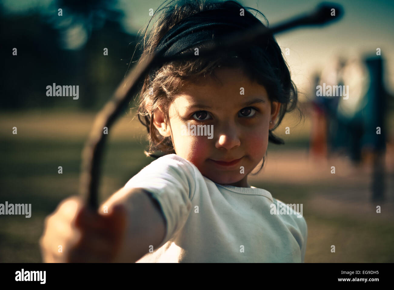 Portrait of a Girl holding a stick Stock Photo - Alamy
