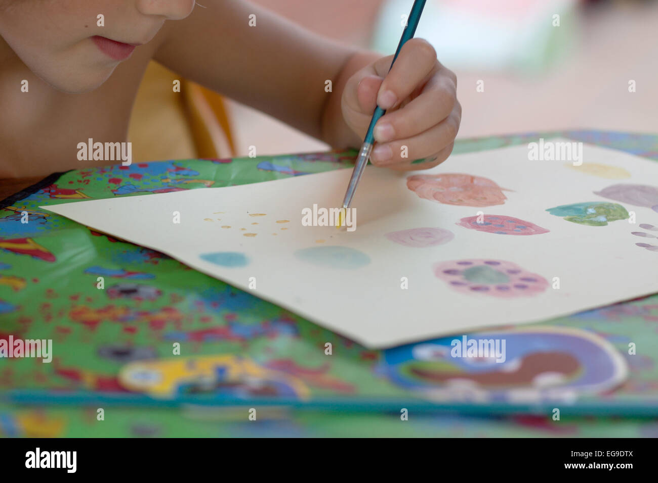 Boy painting with watercolours Stock Photo - Alamy