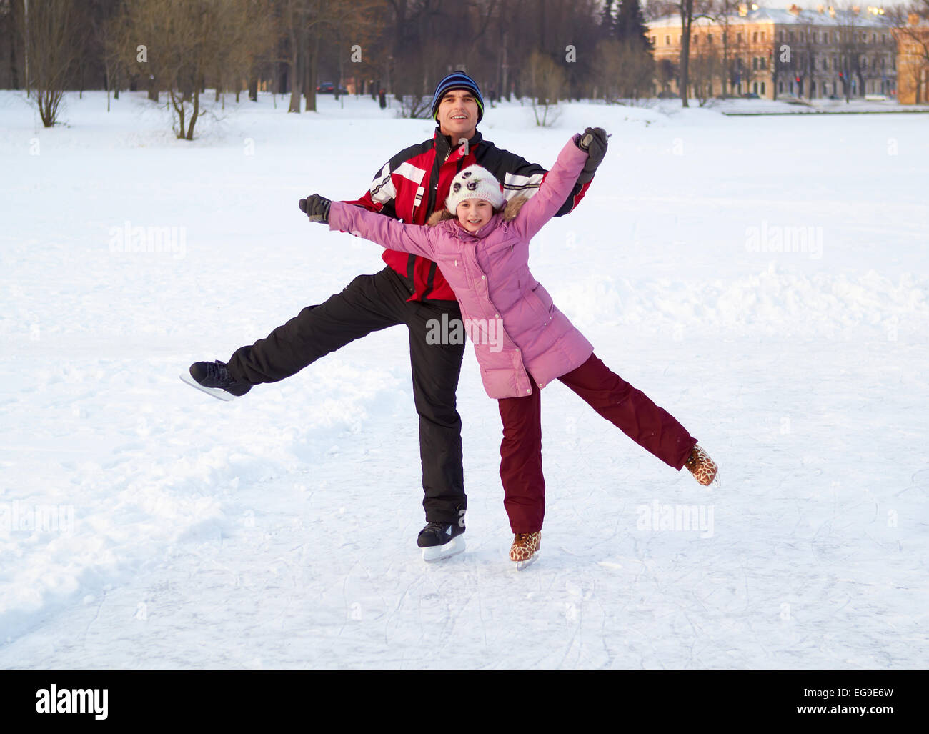 Happy family on skating rink outdoors Stock Photo - Alamy