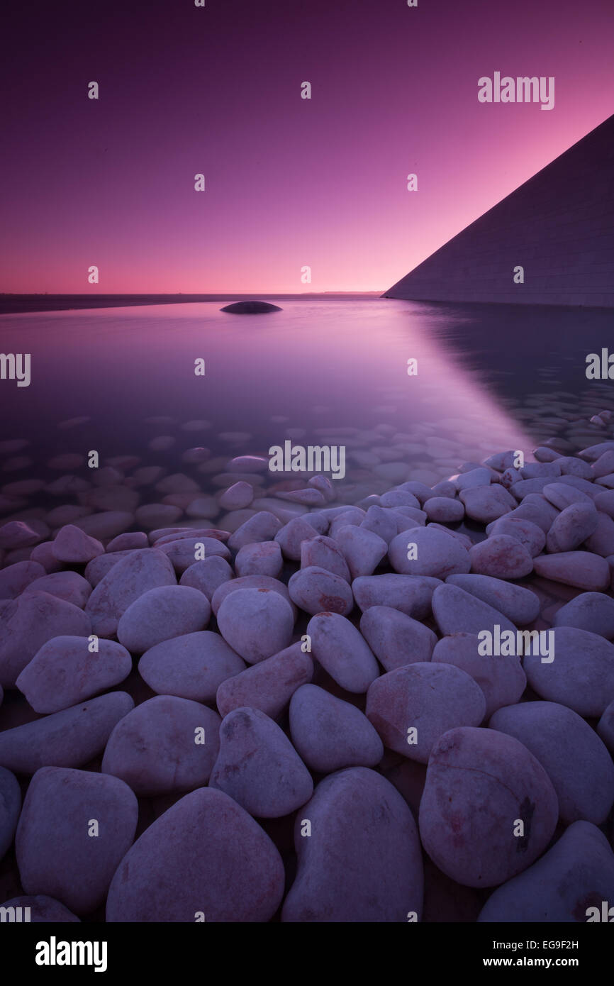 Pebbles at water's edge near where the Tagus river reaches the Atlantic ...