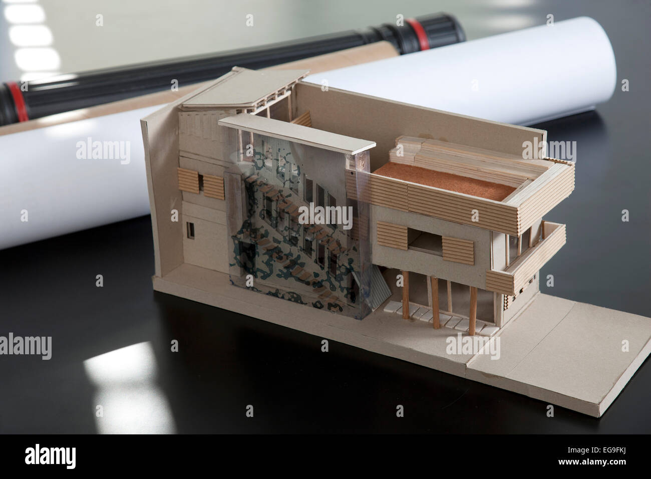 Plans and building model on table Stock Photo - Alamy