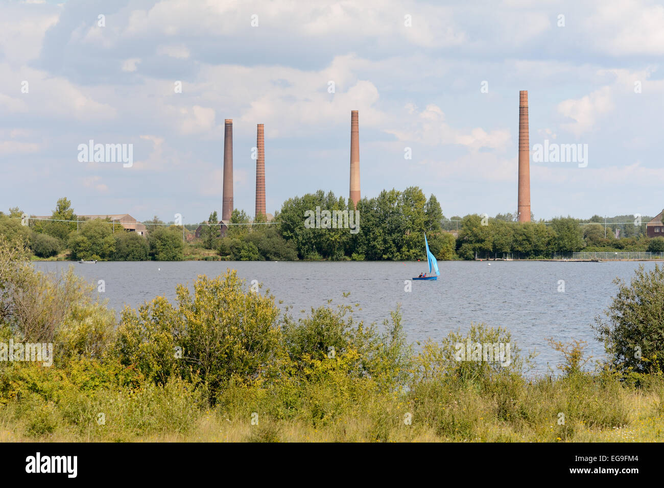 Sailing boat in lake with London Brick Company factory at Stewartby ...
