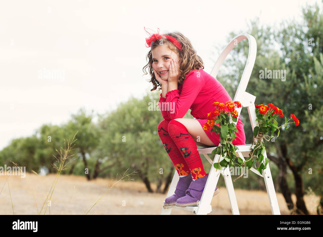 Girl sitting on hands hi-res stock photography and images - Alamy