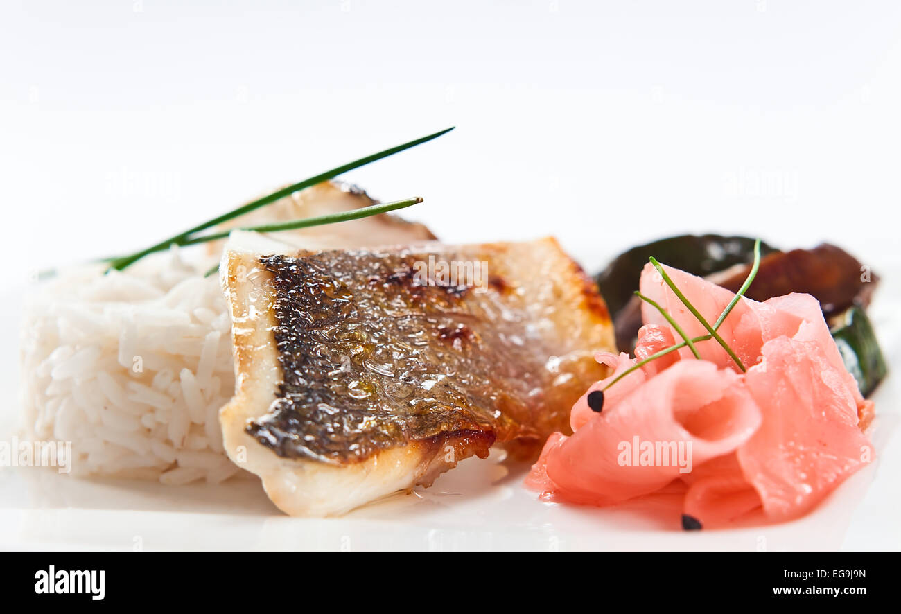 baked fish with ginger and rise on white plate Stock Photo - Alamy