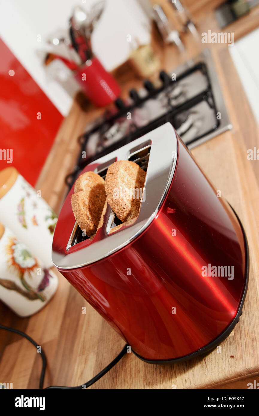 Electrical toaster in kitchen with cooked toast made from brown bread ...