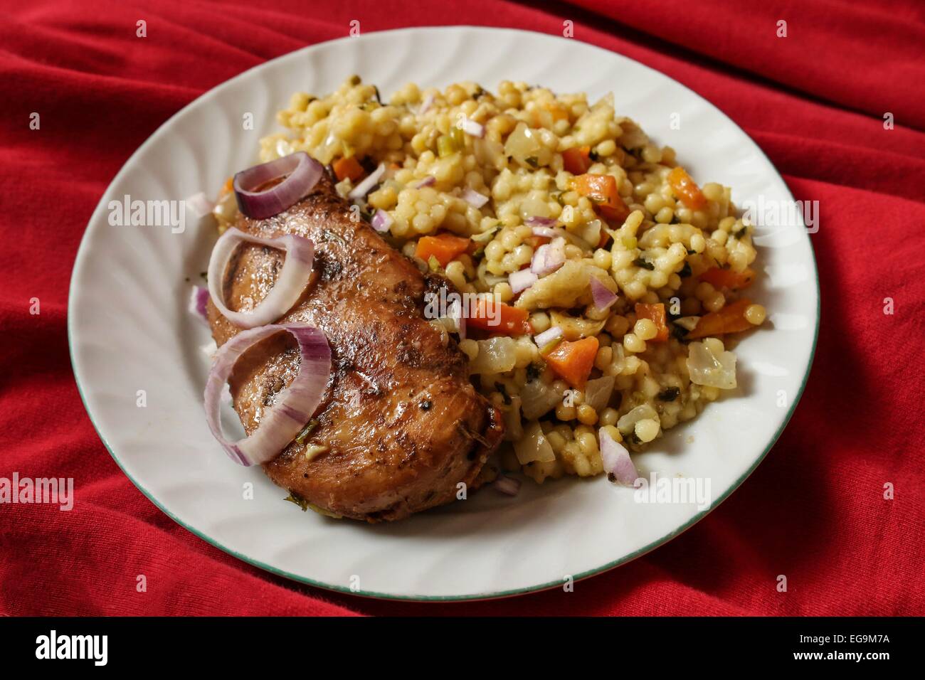 Chicken fillet with oriental rice - red background Stock Photo - Alamy