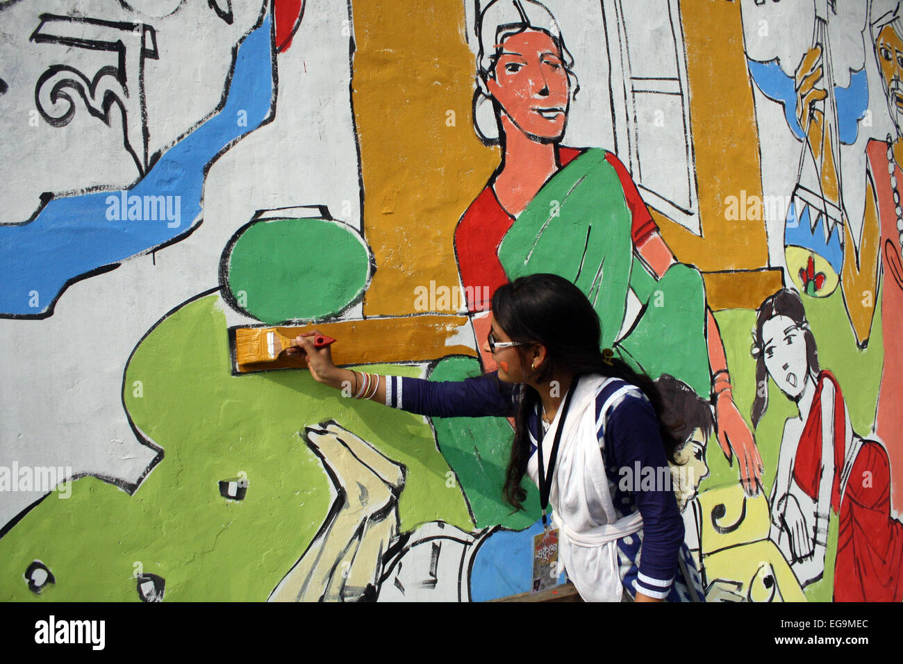 Bangladeshi fine arts students and teachers paint on a wall in front of ...