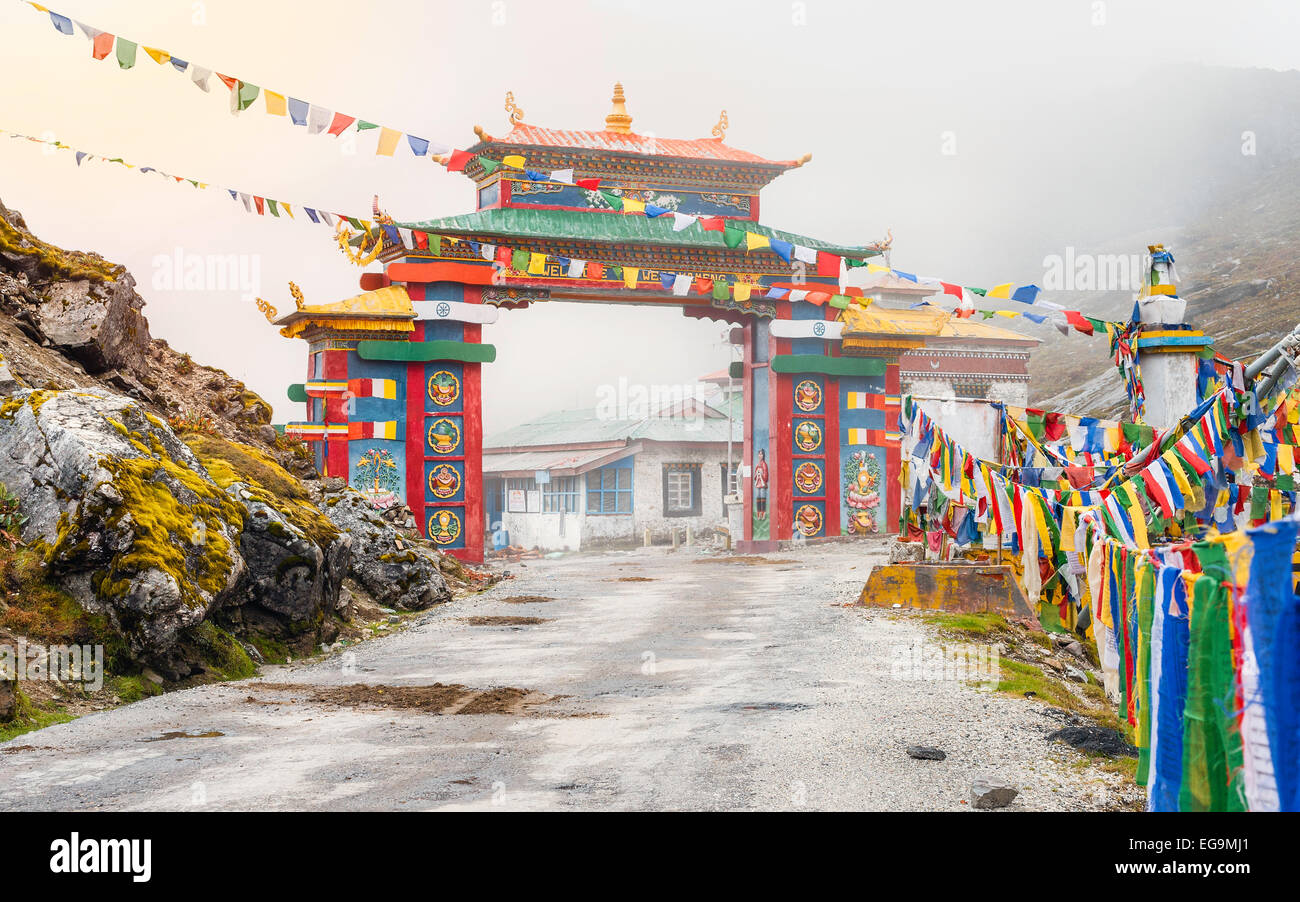 Main road to Tawang via colorful Buddhist gateway at Sela Pass on a ...