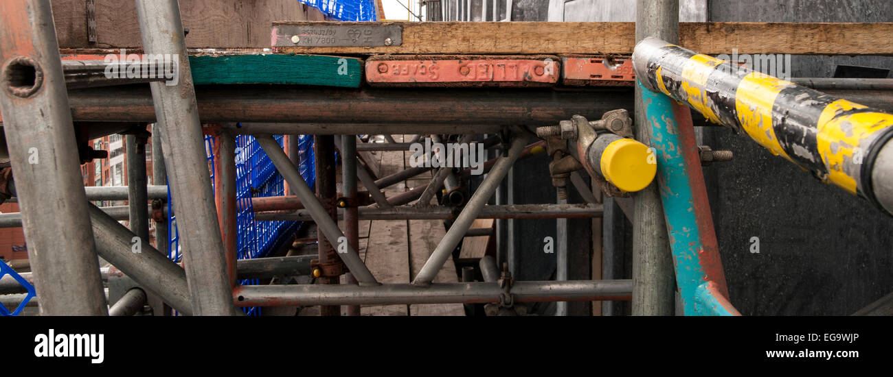 photo of scaffolding showing ends of boards and tubular scaffold poles ...