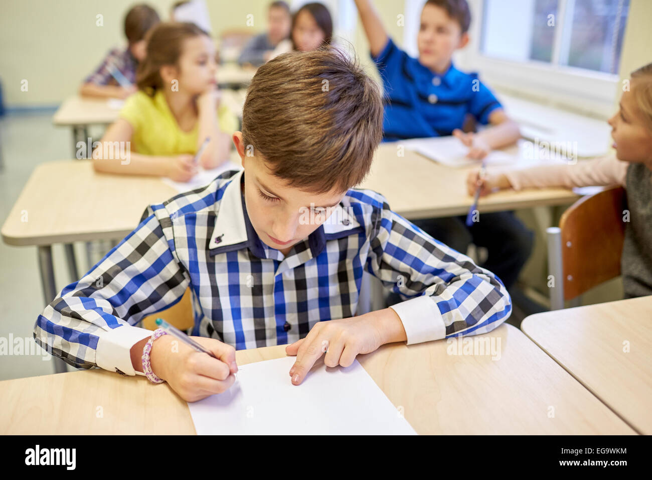 group of school kids writing test in classroom Stock Photo - Alamy