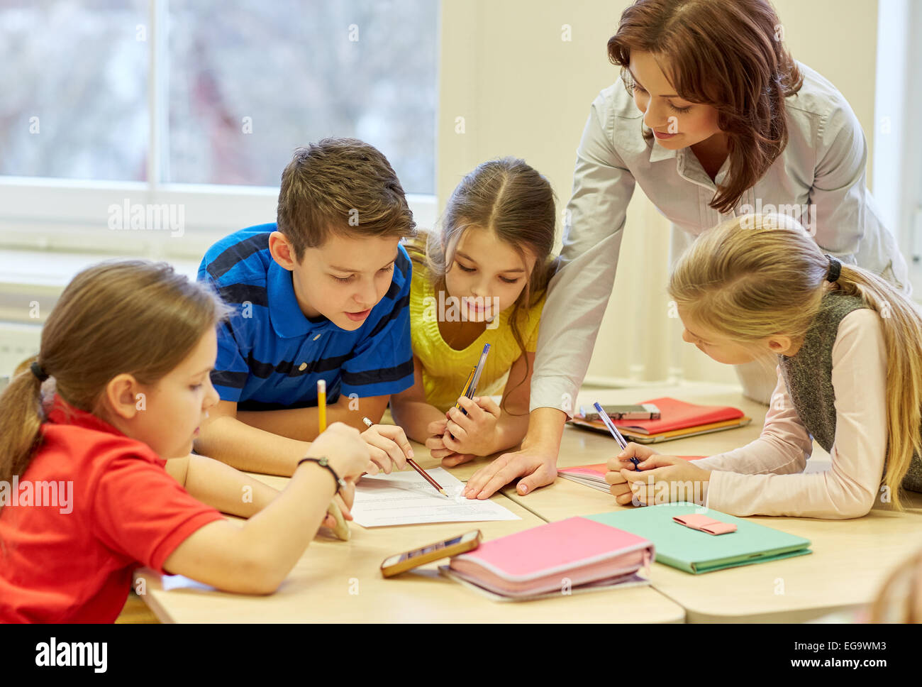 group of school kids writing test in classroom Stock Photo - Alamy