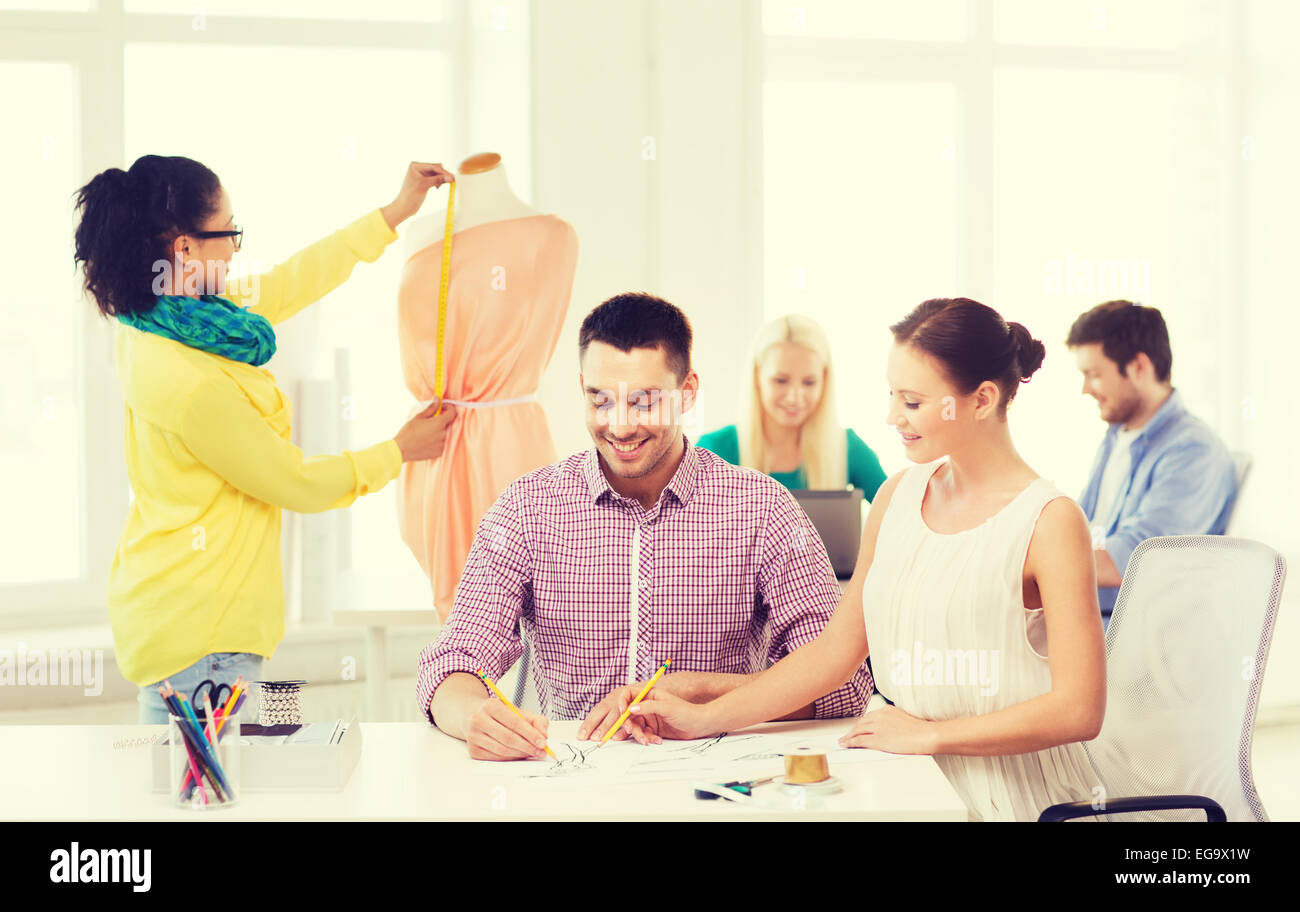smiling fashion designers working in office Stock Photo - Alamy