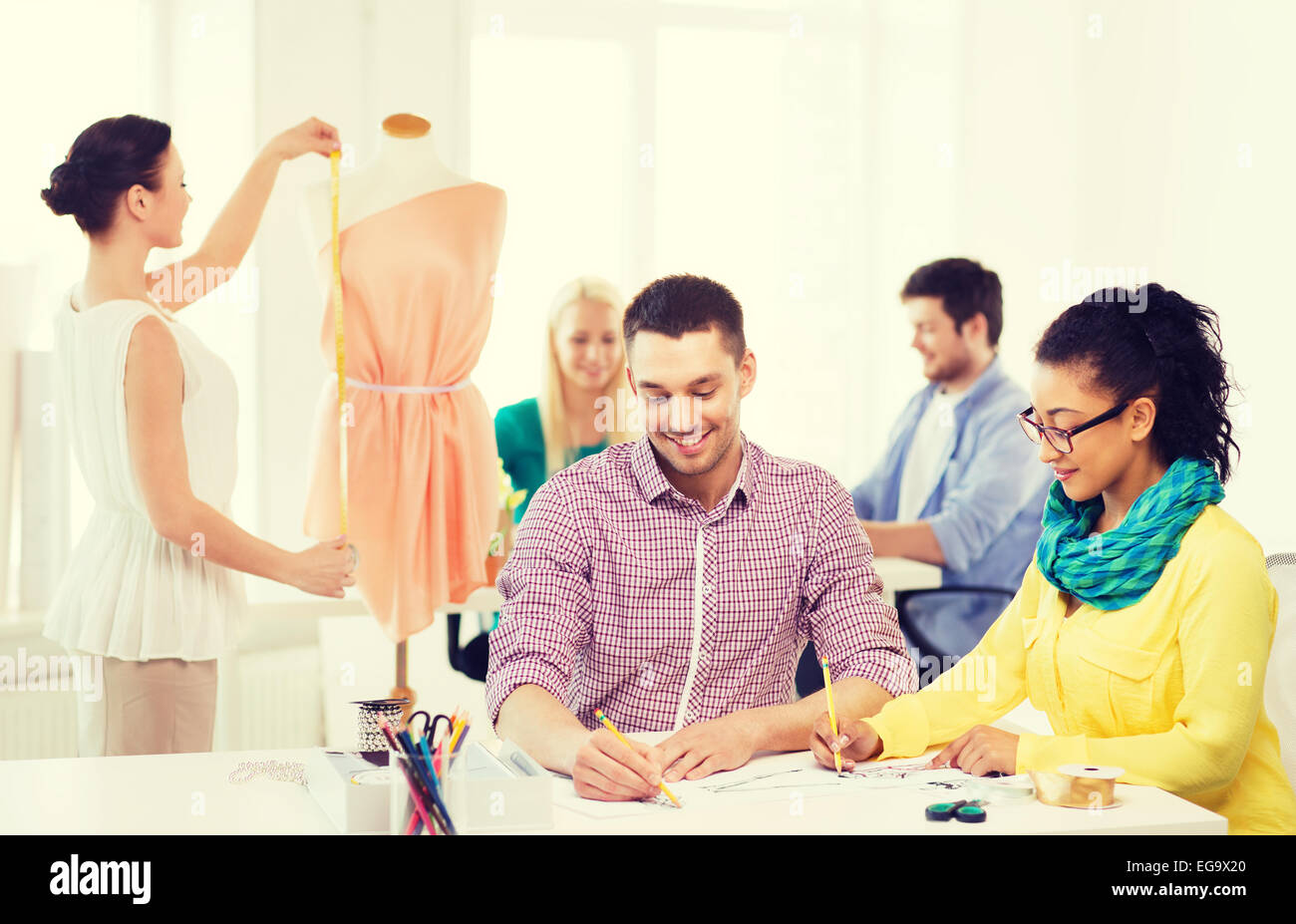 smiling fashion designers working in office Stock Photo - Alamy