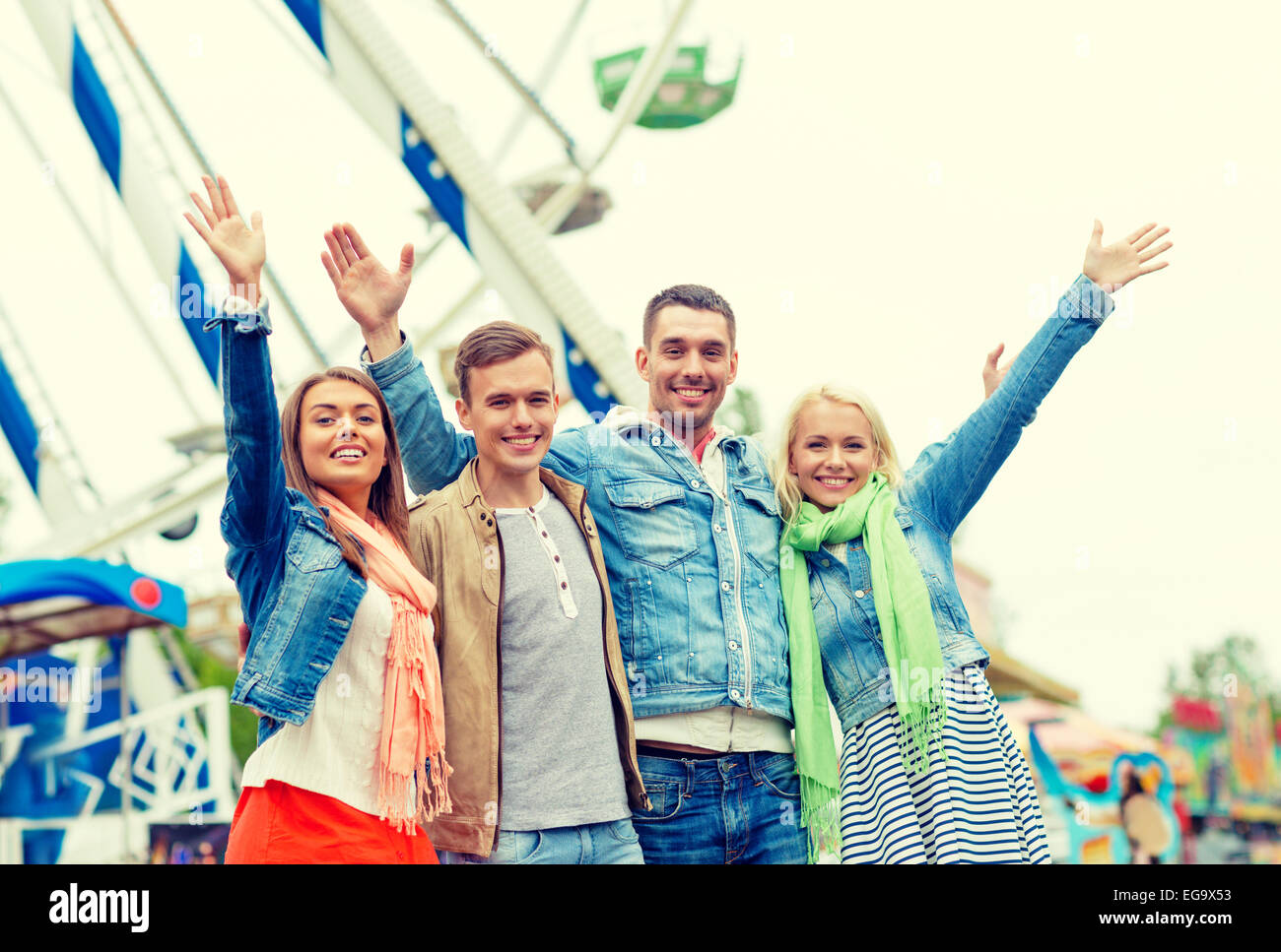 group of smiling friends waving hands Stock Photo - Alamy