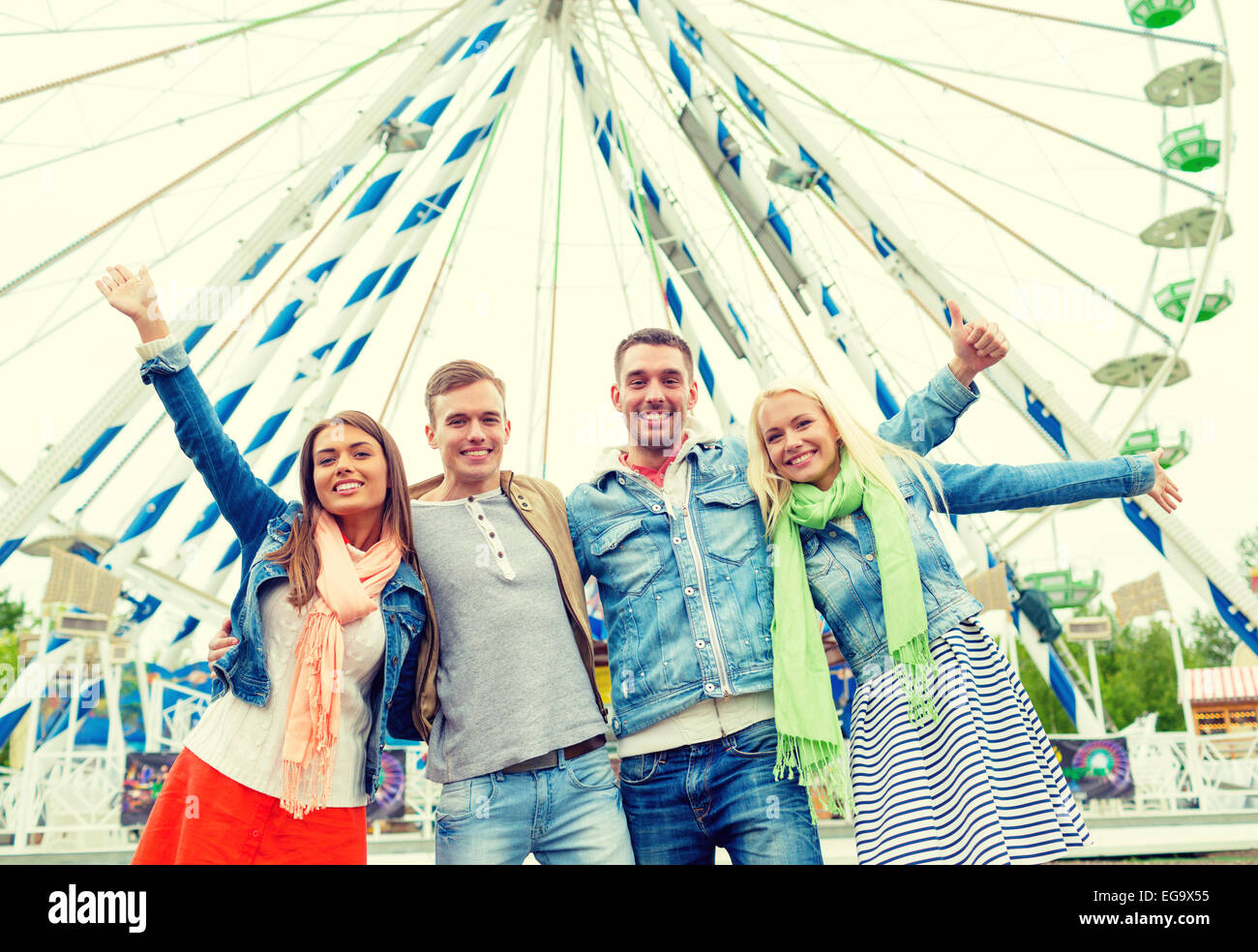 group of smiling friends waving hands Stock Photo - Alamy