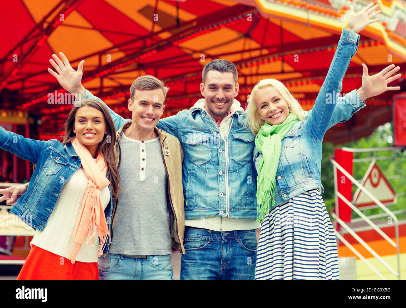 group of smiling friends waving hands Stock Photo - Alamy