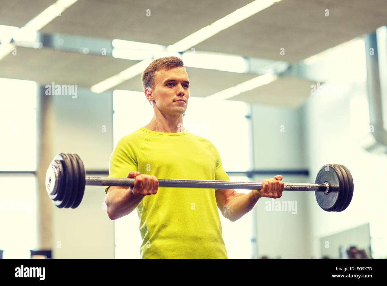 man doing exercise with barbell in gym Stock Photo - Alamy