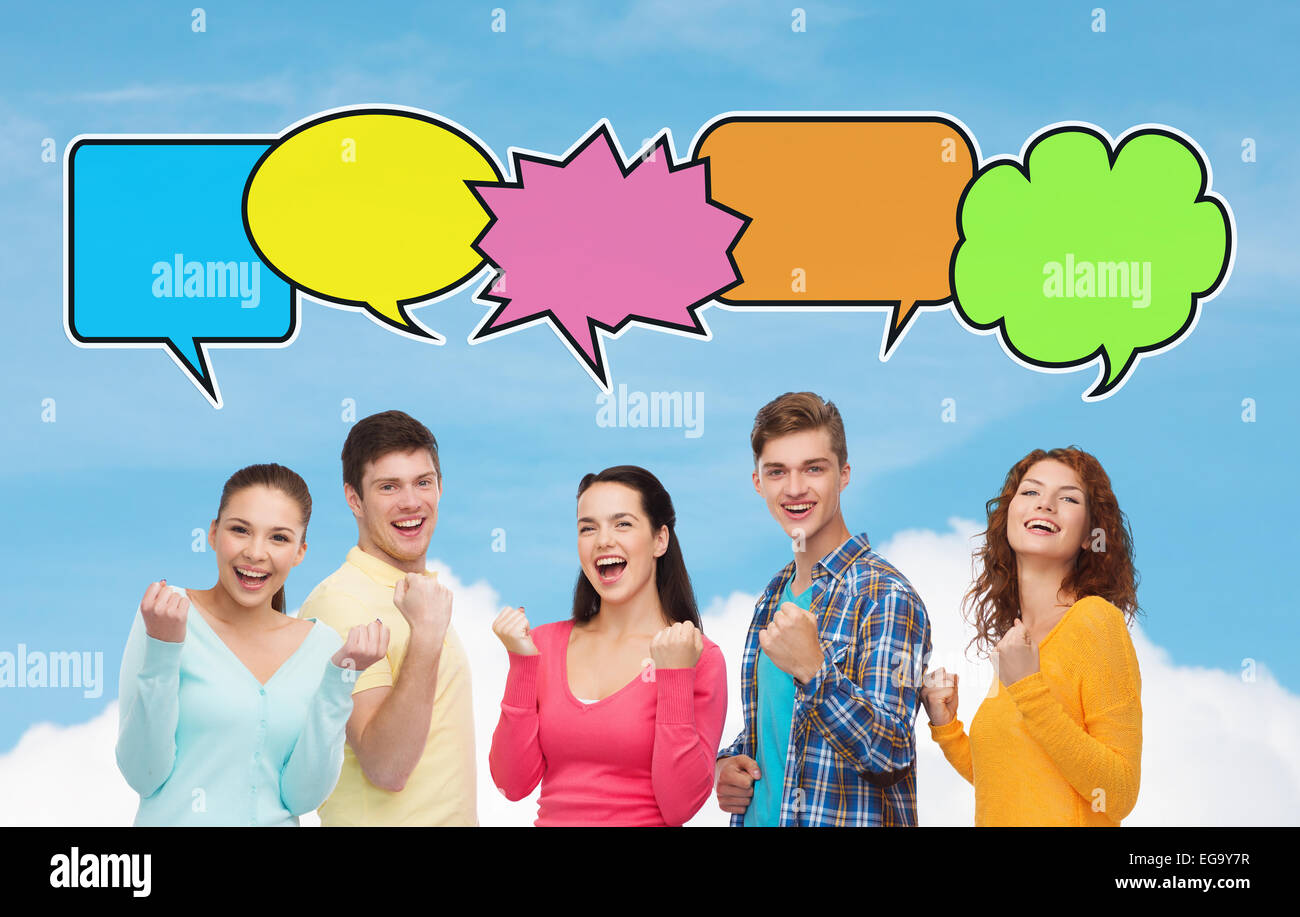 group of smiling teenagers showing triumph gesture Stock Photo - Alamy