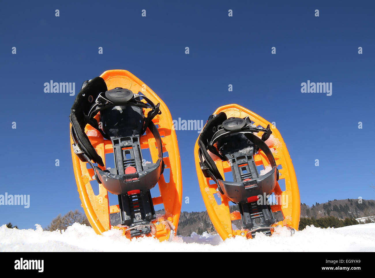 pari of orange modern snowshoes in the mountain Stock Photo - Alamy