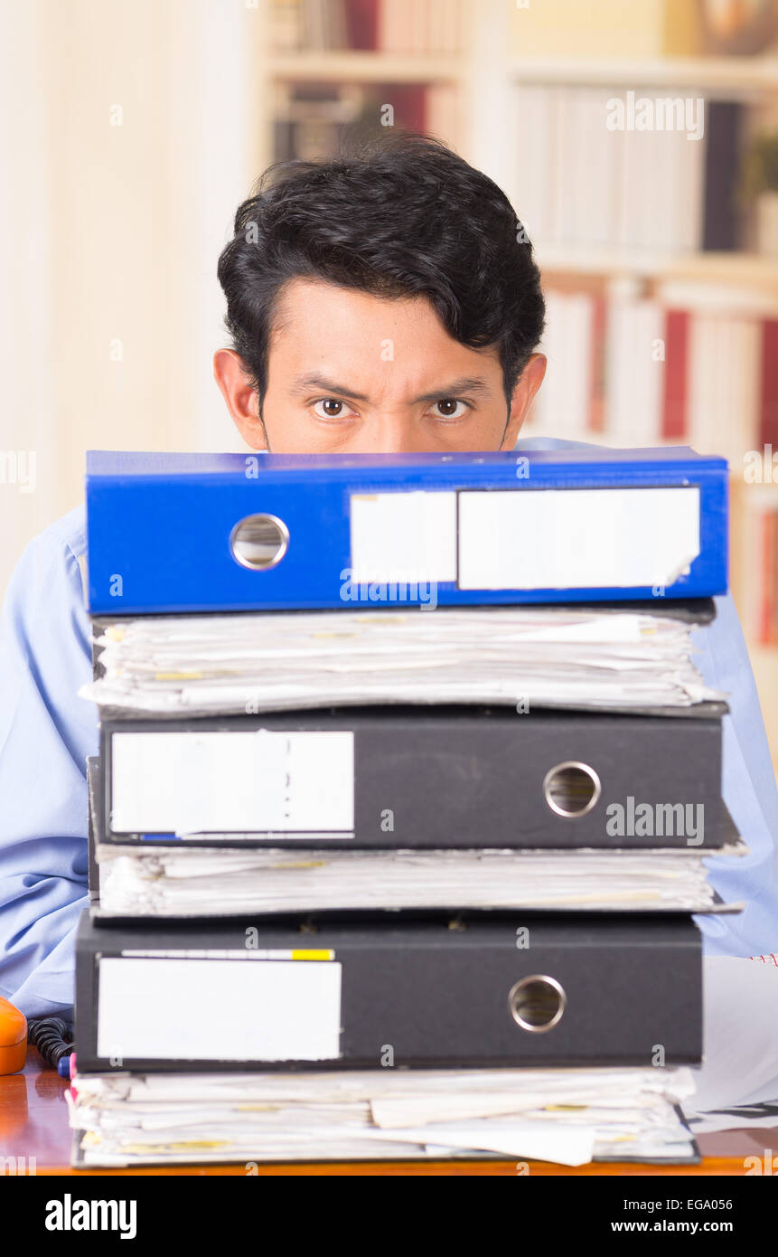young stressed overwhelmed man with piles of folders on his desk Stock ...