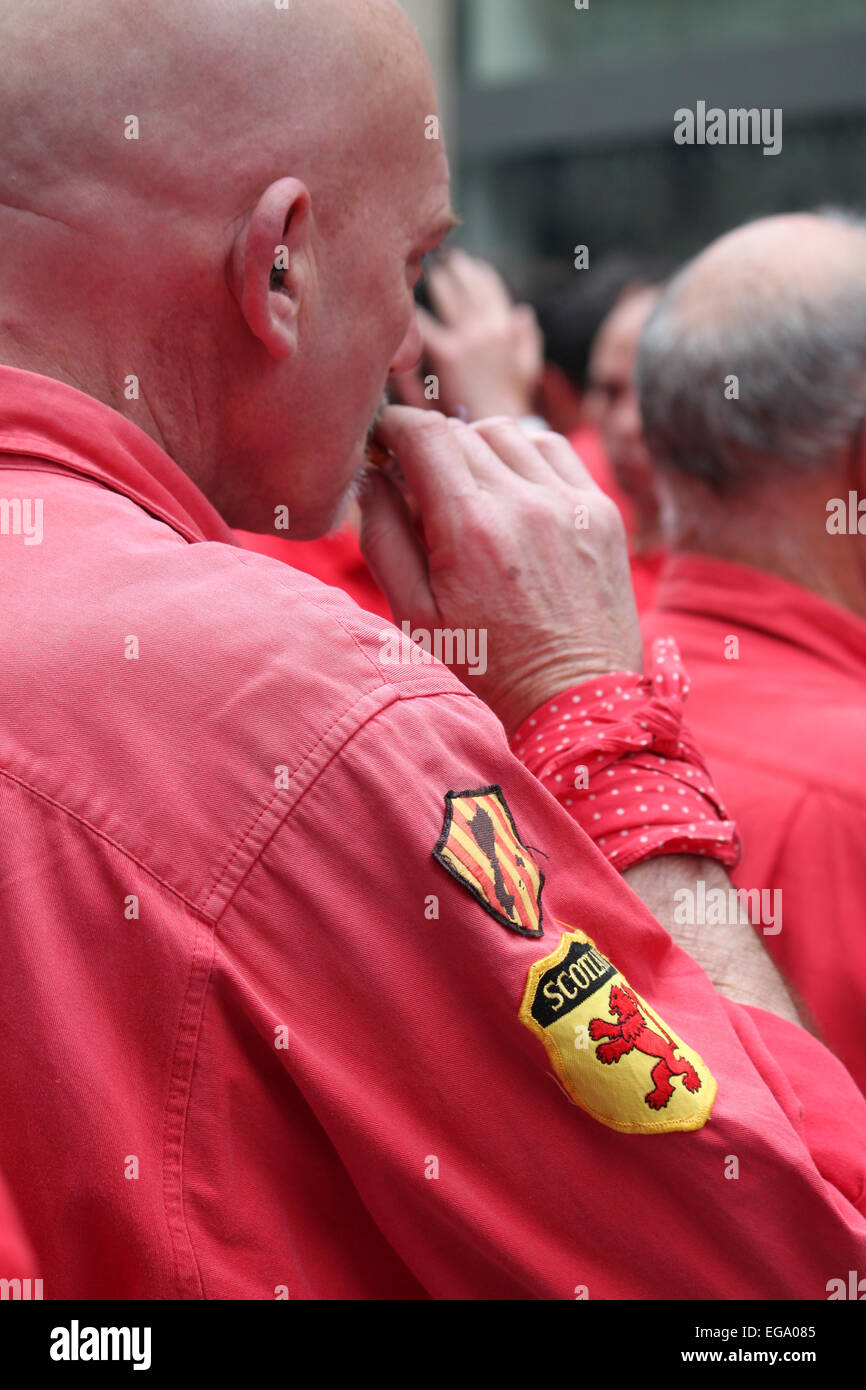 Man wearing traditional Castellers costume with Catalonia and Scotland ...