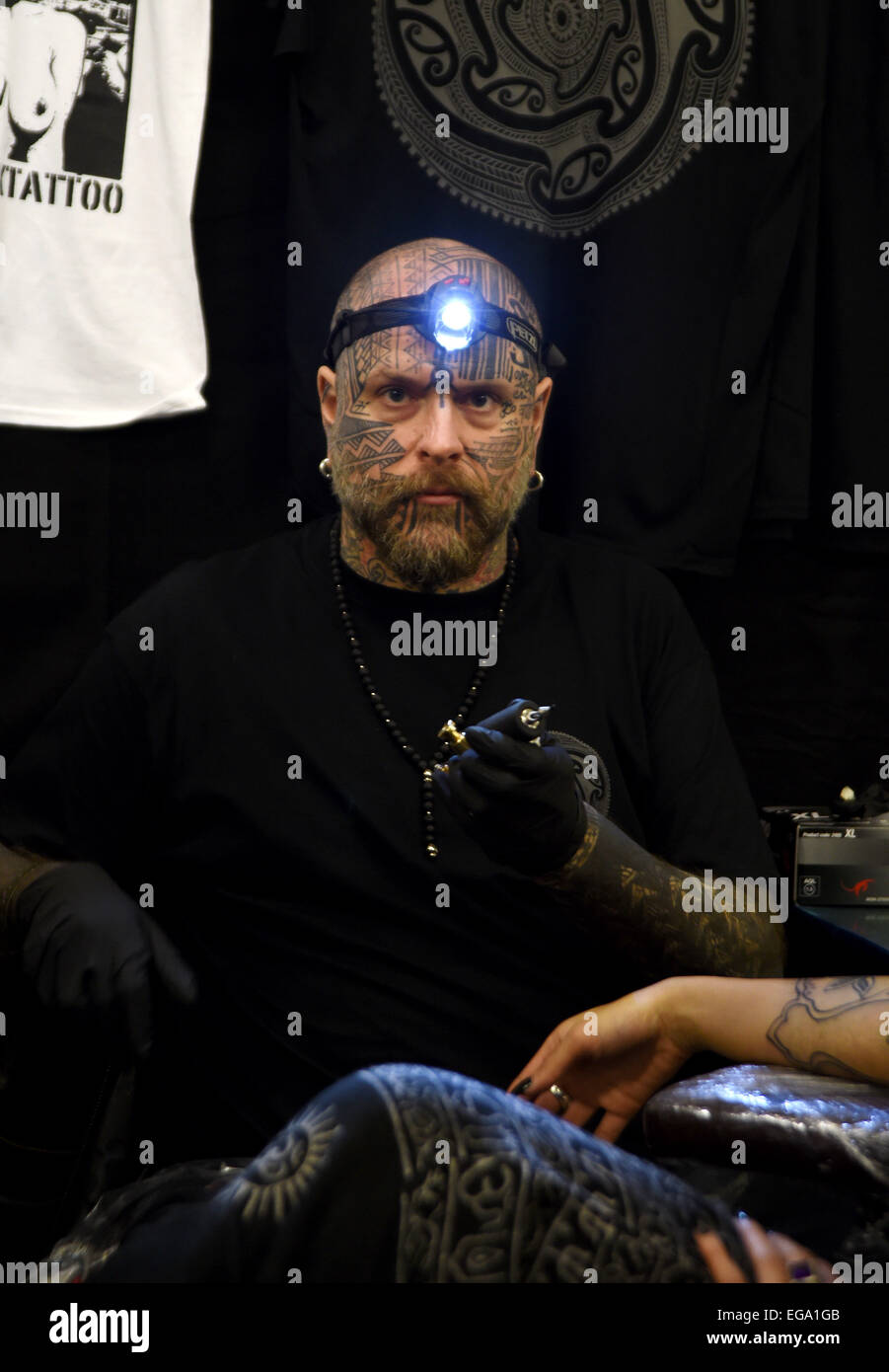 Brighton, UK. 20th February, 2015. Tattoo artist Matt Black at work the ...