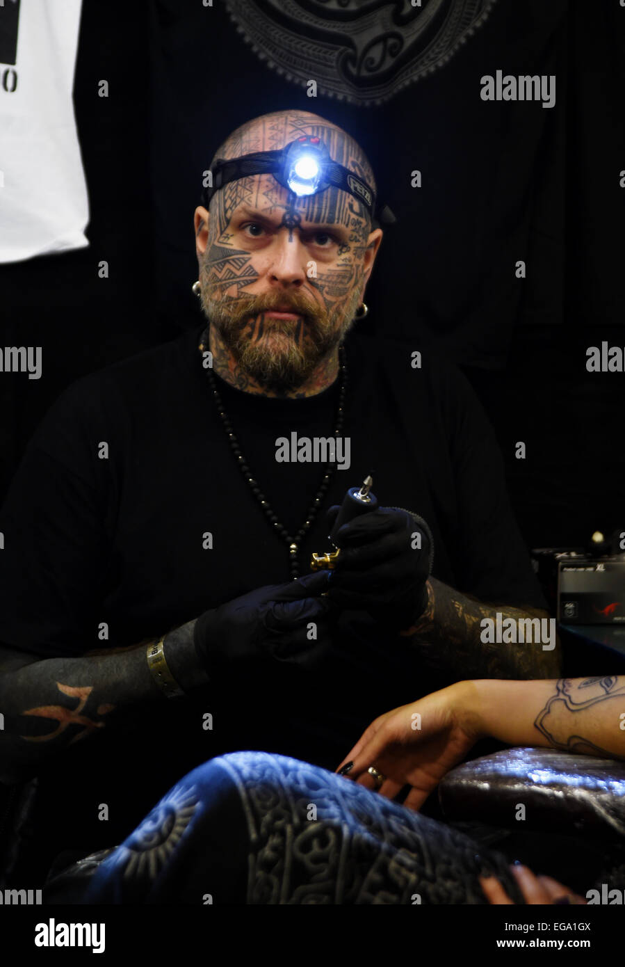Brighton, UK. 20th February, 2015. Tattoo artist Matt Black at work the ...