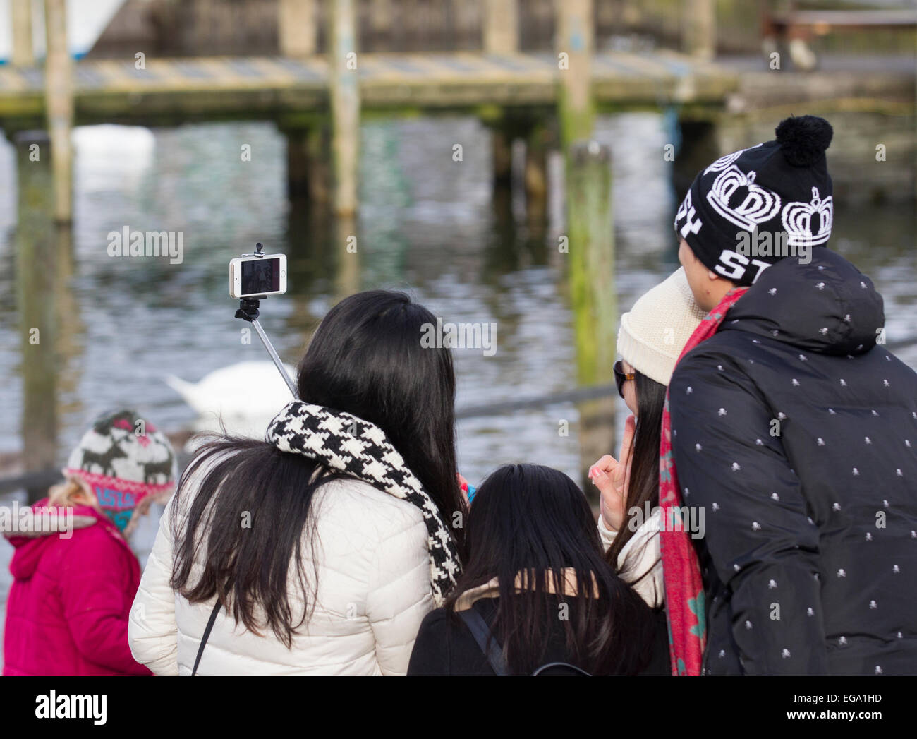 Take selfies using selfie sticks hi-res stock photography and images ...