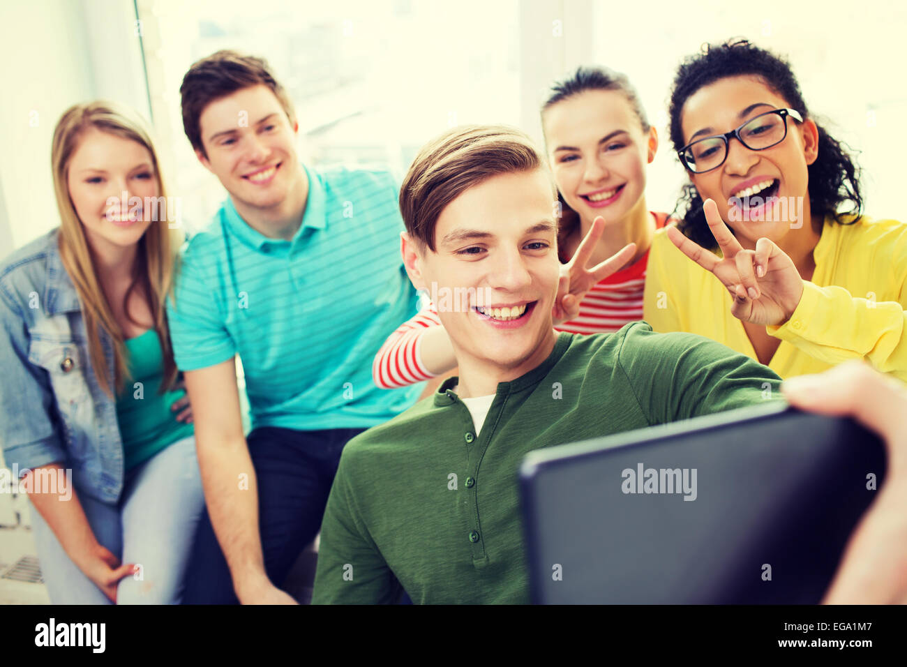 smiling students making selfie with tablet pc Stock Photo - Alamy