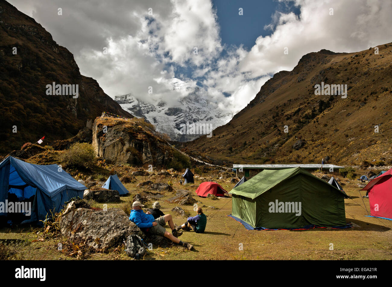 BHUTAN -A cloud covered Jhomolhari and a ruined watchtower stand guard ...