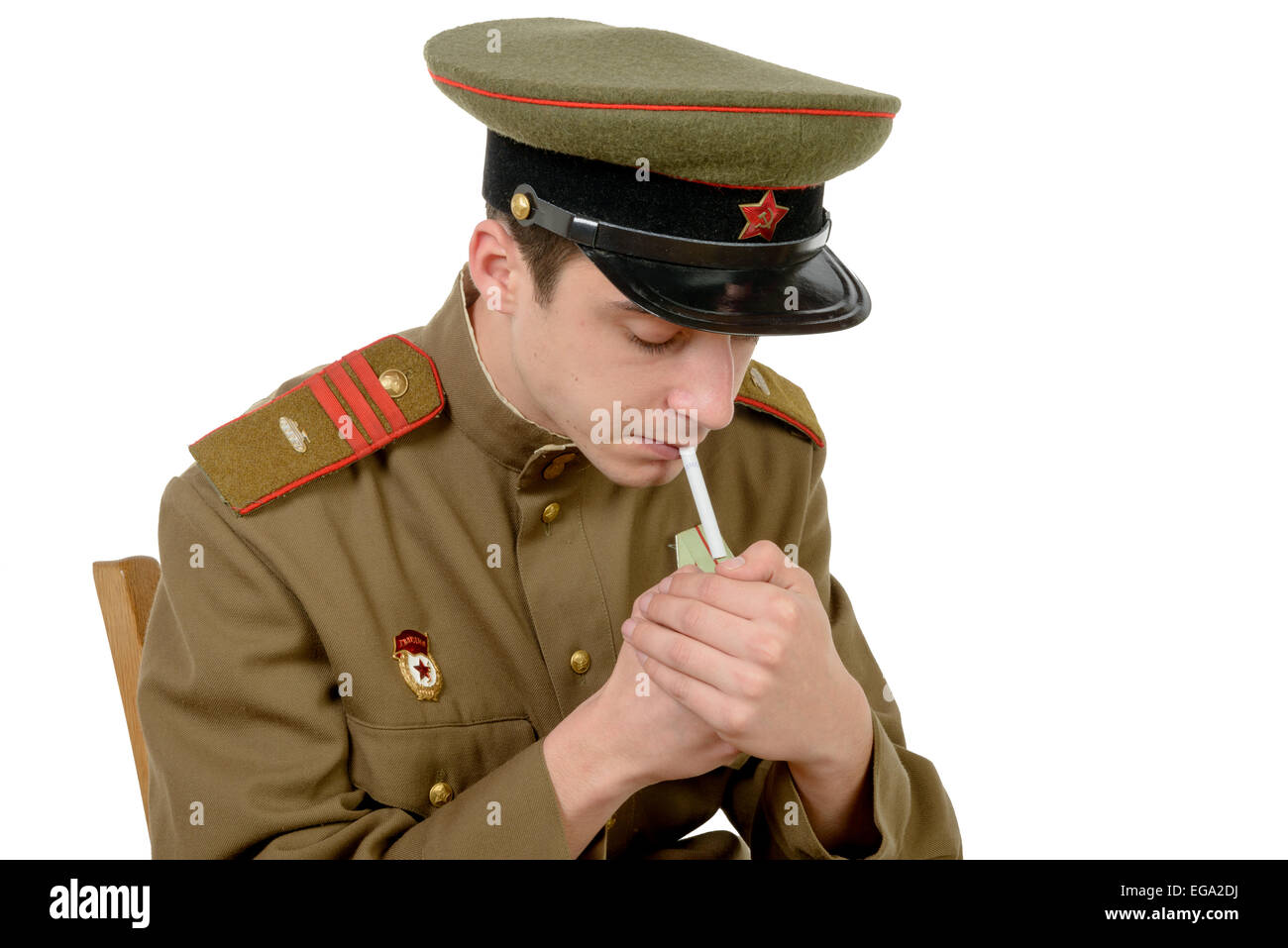 a young Soviet officer sitting in a chair smoking a cigarette Stock ...
