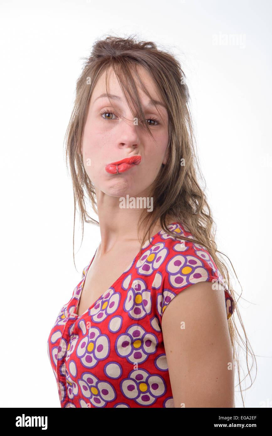 a young woman makes a grimace on the white background Stock Photo - Alamy
