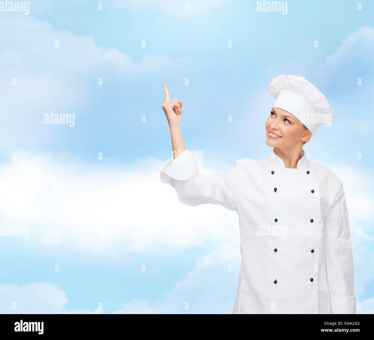 smiling female chef pointing finger to something Stock Photo - Alamy