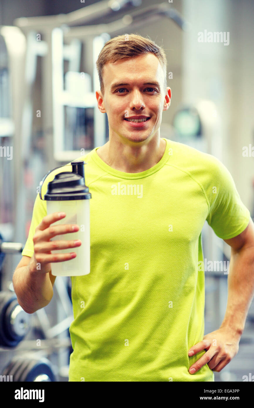 smiling man with protein shake bottle Stock Photo - Alamy