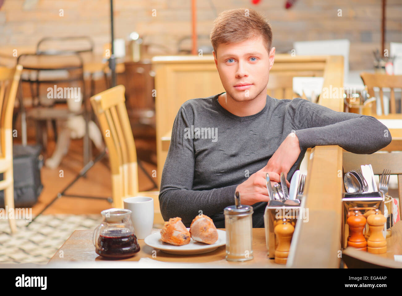 Inspired by cup of fresh coffee. Handsome young man enjoying coffee in ...