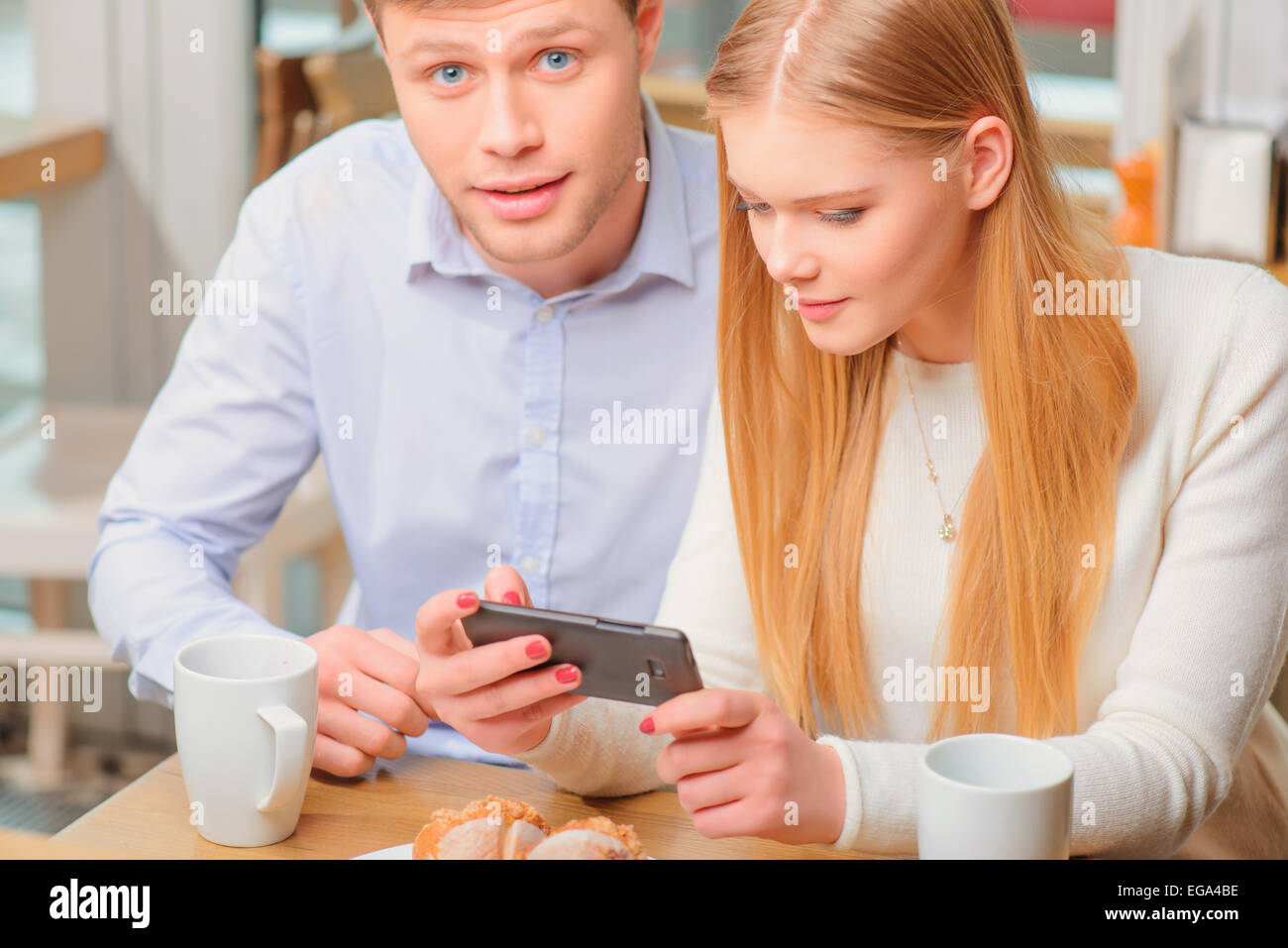 No minute without technologies. Beautiful young loving couple bonding ...