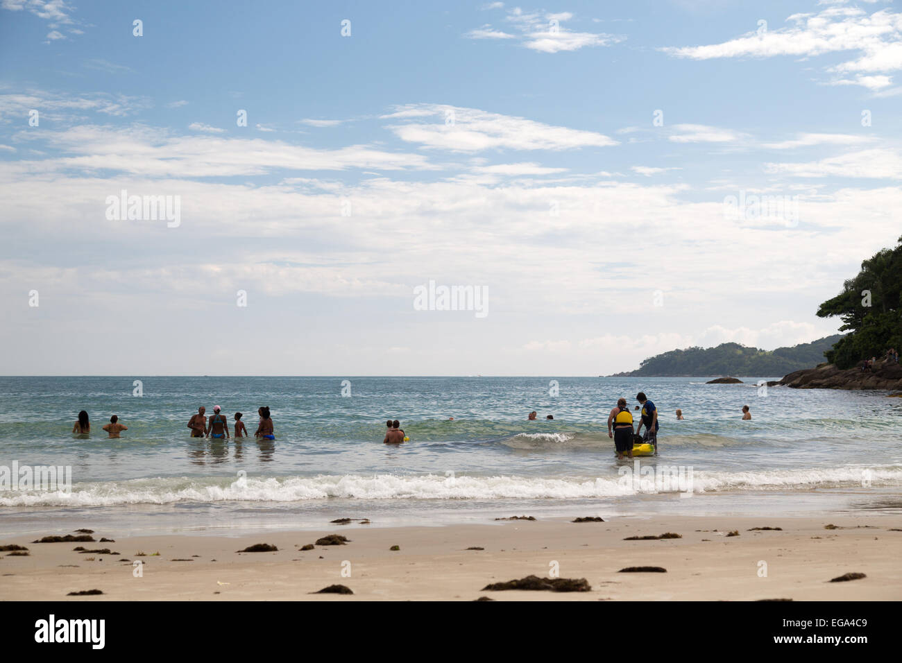 Vacationers at the beach. Praia do Ribeiro is a small rugged beach ...