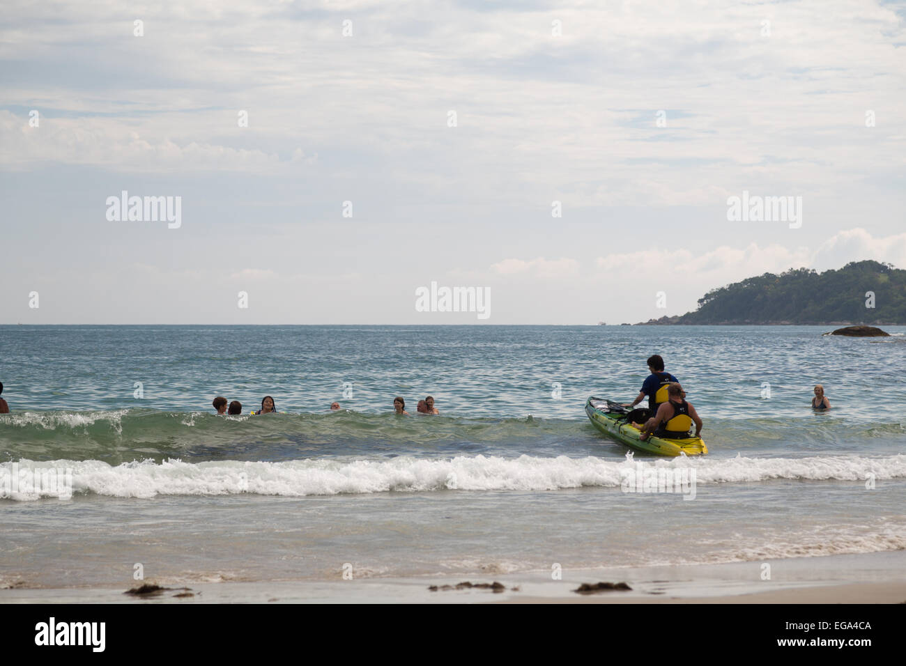 Vacationers and kayak at the beach. Praia do Ribeiro is a small rugged ...