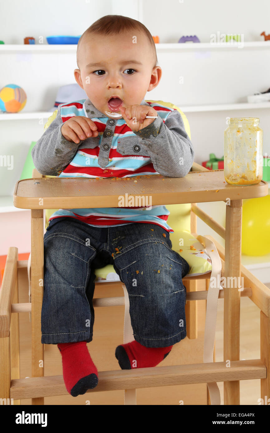 Little child eating baby food with spoon Stock Photo - Alamy