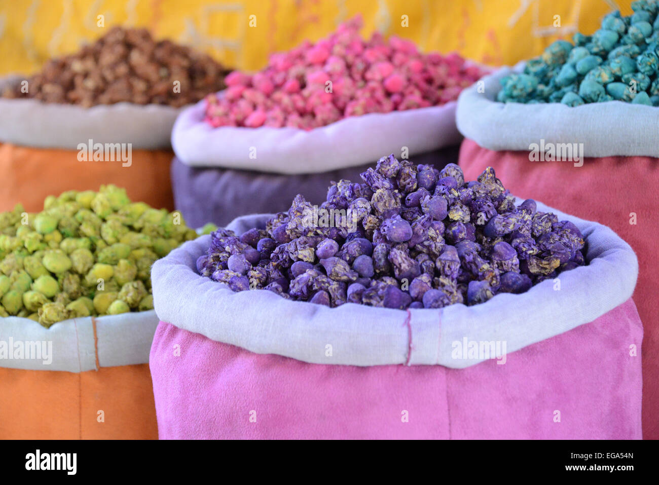 Colourful spice containers and dried flower heads, Marrakech, Morocco ...