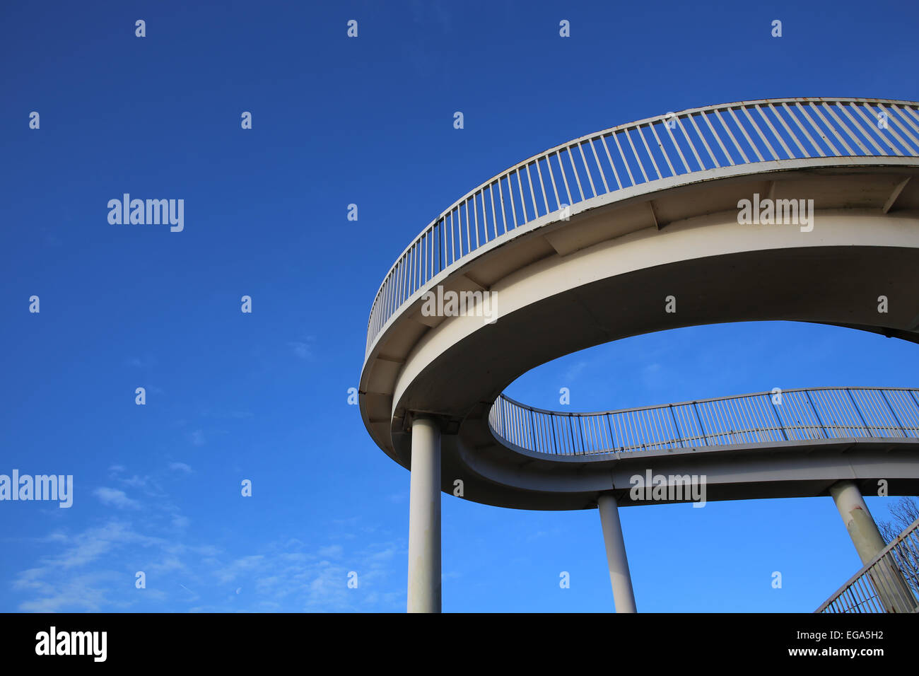 A curved public footbridge over the Southend to London train line, at ...