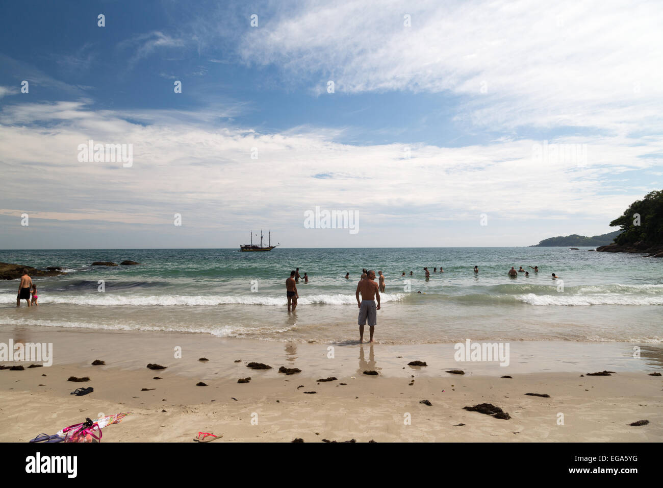Vacationers at the beach. Praia do Ribeiro is a small rugged beach ...