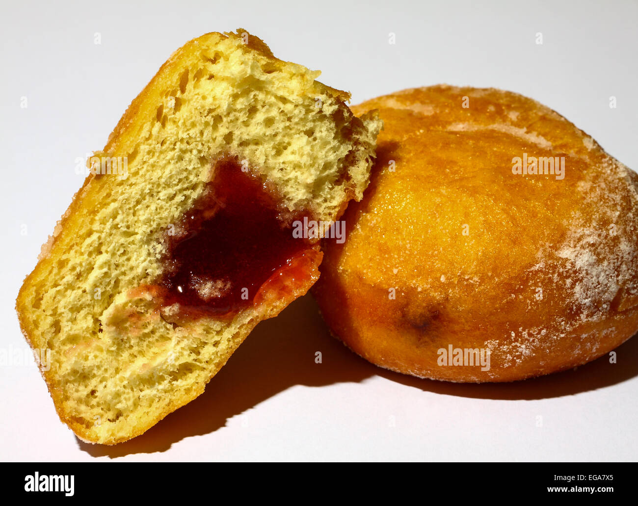 Doughnut sliced in half with jam oozing out Stock Photo - Alamy